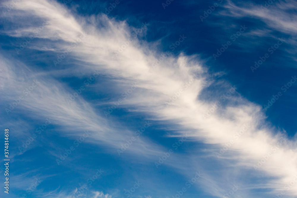 High white wispy cirrus clouds with cirro-stratus in the blue ...