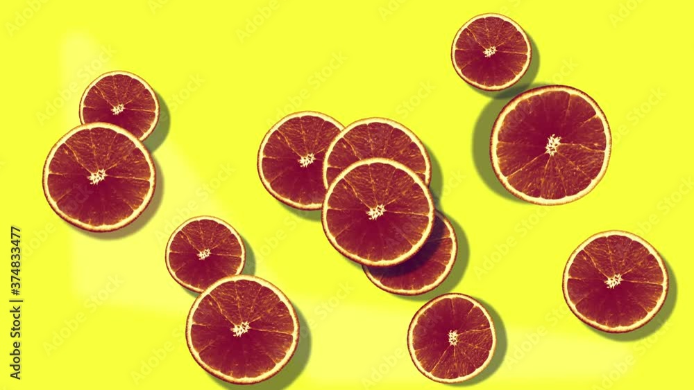 Funny colourful citrus yellow background. Rotating and flying orange ...