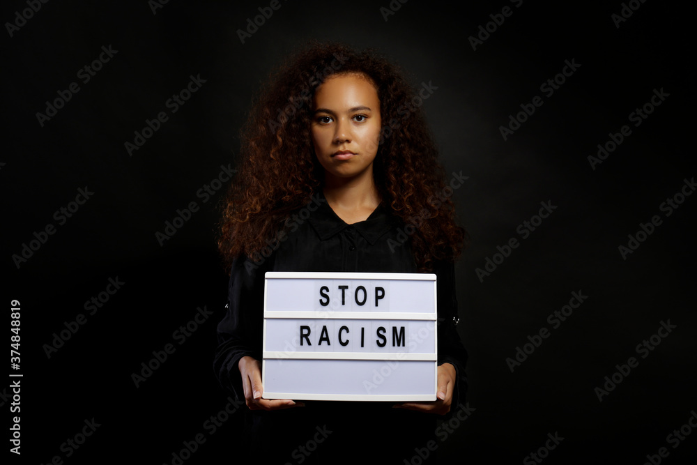 Portrait of young beautiful black woman standing in the dark with anti ...