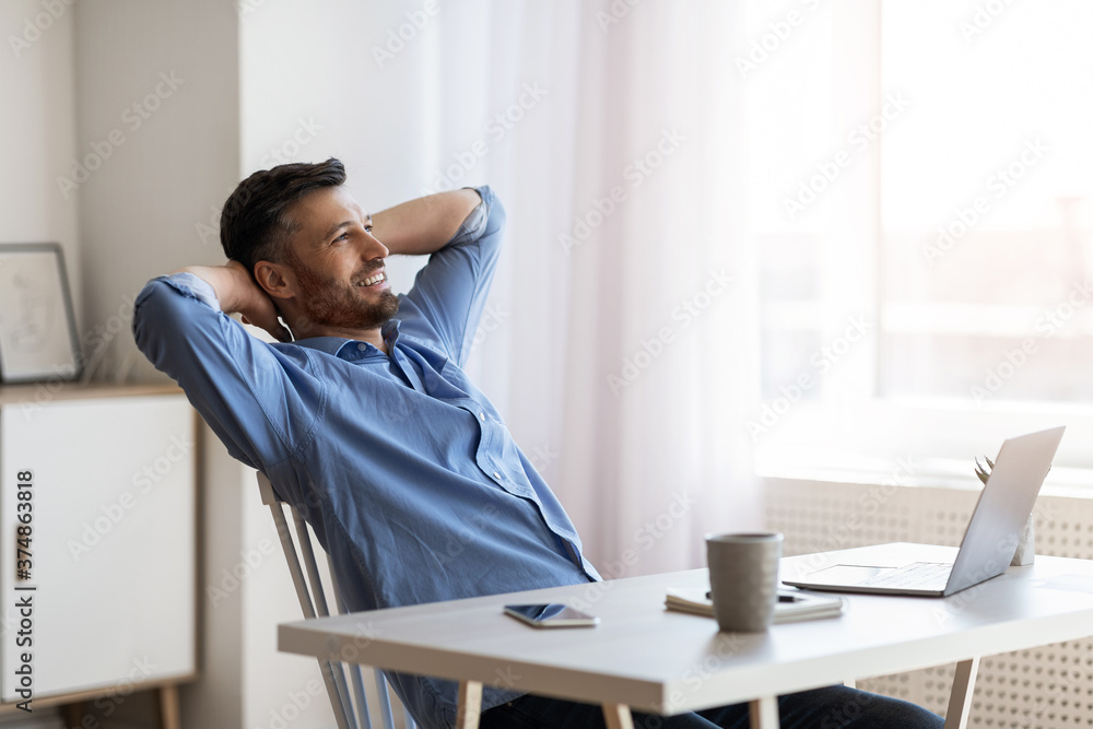 Daydreaming At Work. Successful entrepreneur relaxing at workplace with ...