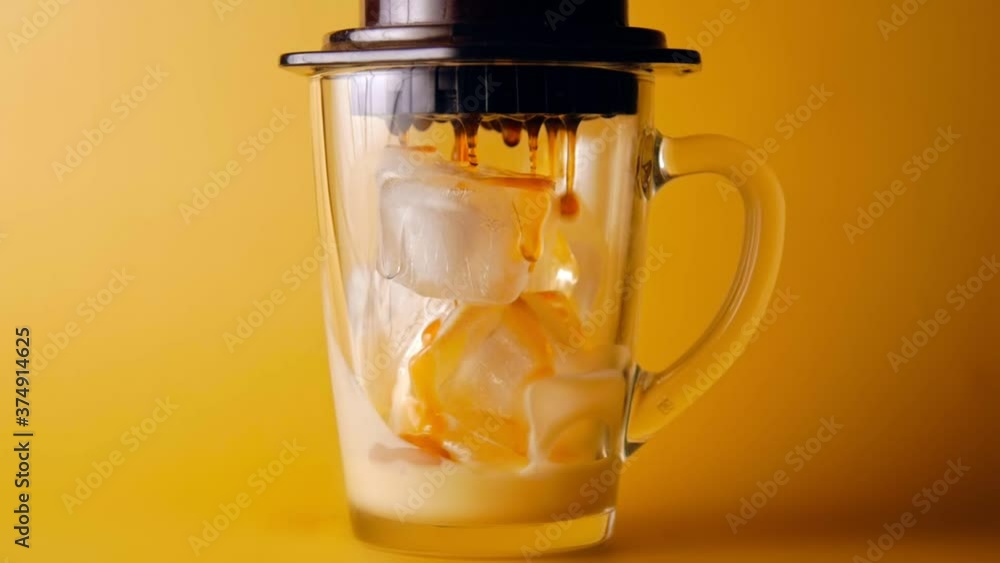 Coffee dripping into glass mug - ice beverage with Condensed milk Stock ...