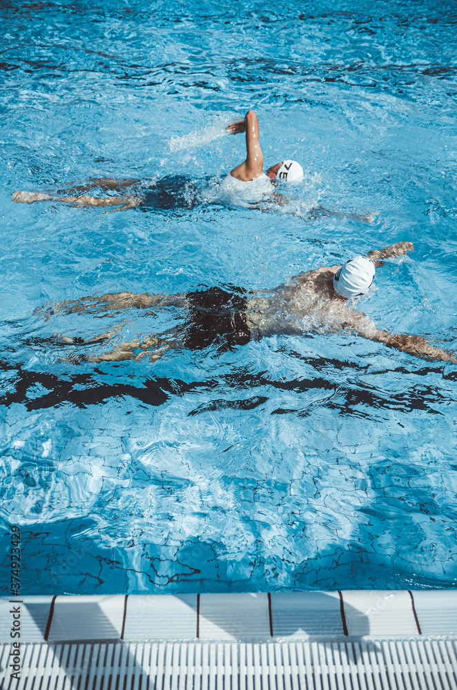 Triathlon competitors in swim , triathletes in action and motion in ...