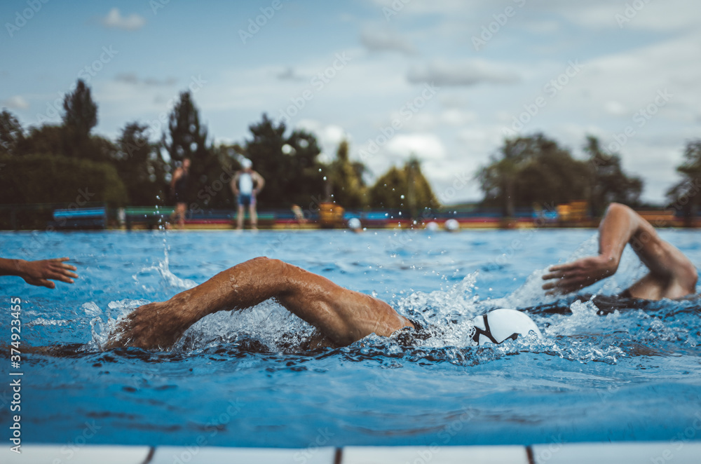 Triathlon competitors in swim , triathletes in action and motion in ...