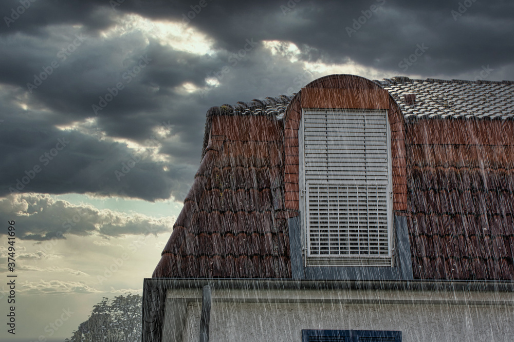 Roof and window of a modern house in a heavy rain shower with dark sky ...