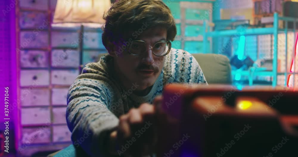 Caucasian funny young man nerd in glasses and with mustache sitting in ...