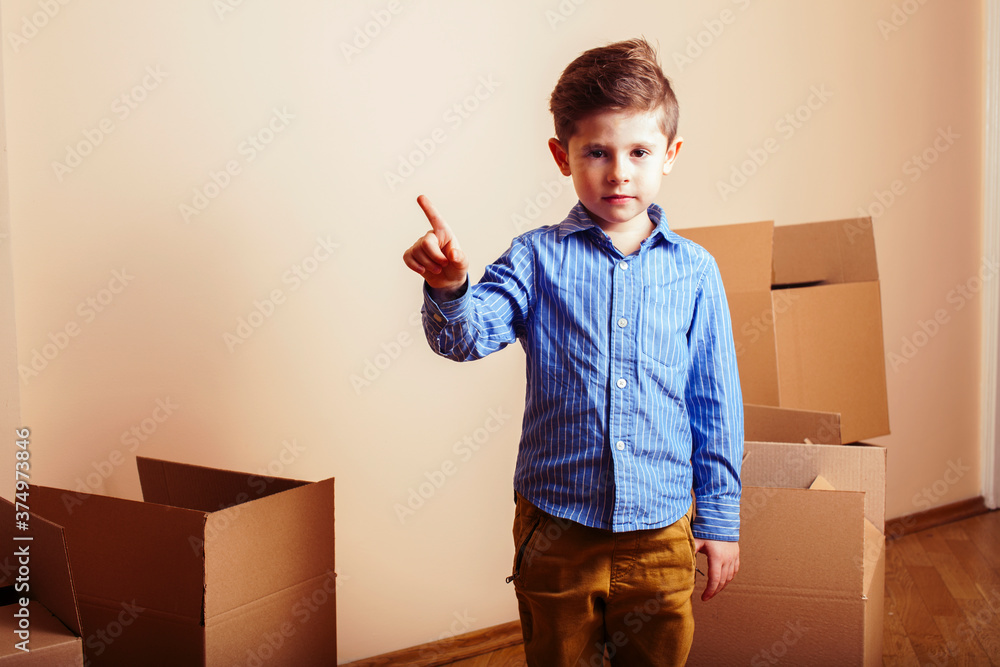little cute boy in empty room, move to new house. home alone among ...