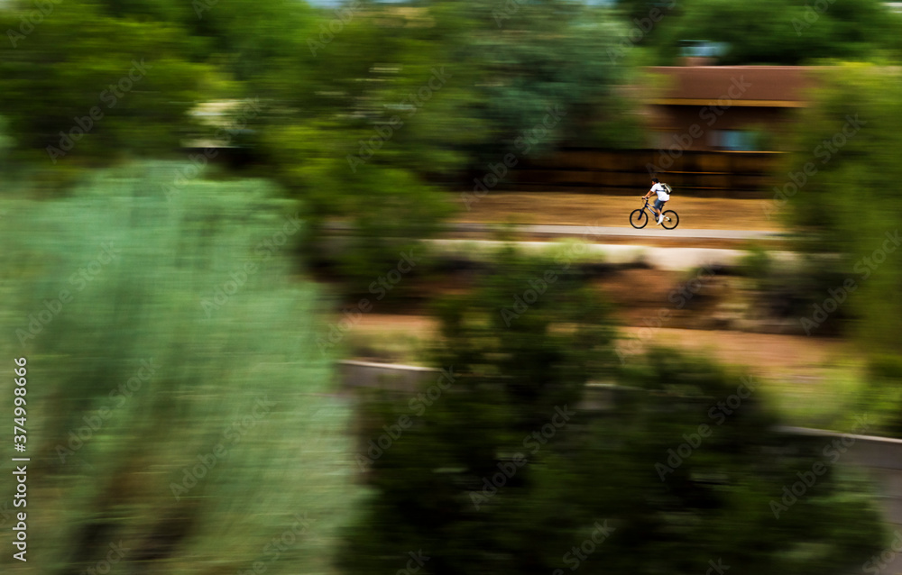 Cyclist in motion Stock Photo | Adobe Stock