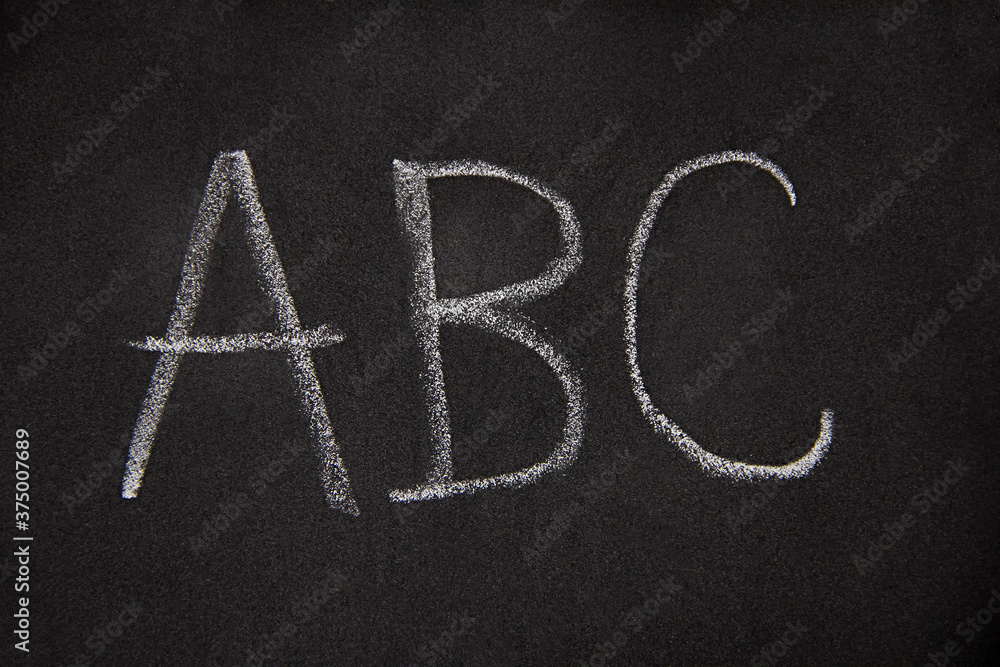 the letters A, B, C isolated on black, closeup of first english ...