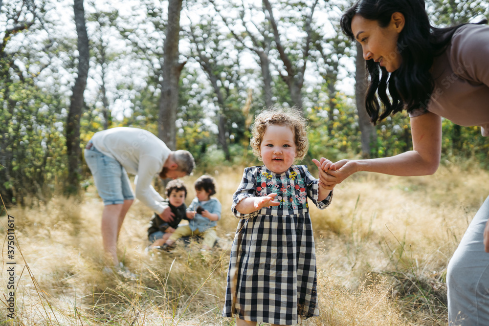 Fun loving family of five hanging out together in grassy nature. Stock ...