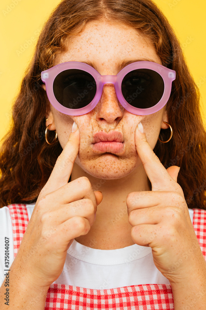 Funny ginger girl with pouting cheeks Stock Photo | Adobe Stock