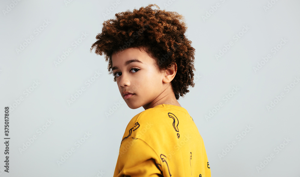 Ethnic kid with back facing camera Stock Photo | Adobe Stock