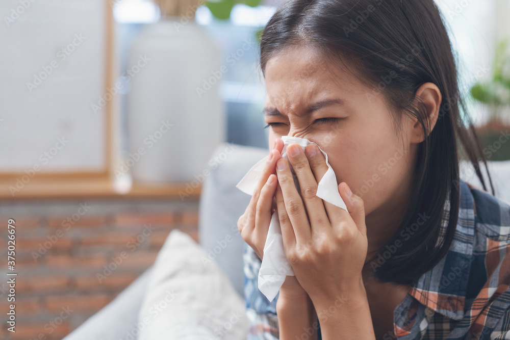 Sick day at home. Asian woman has runny and common cold. Stock Photo ...