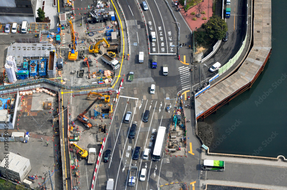 Aerial view of road construction work with excavators at Tokyo and ...