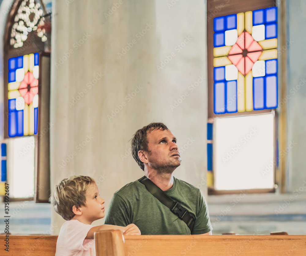 Christian dad tells his son Bible stories about Jesus sitting in kirk ...
