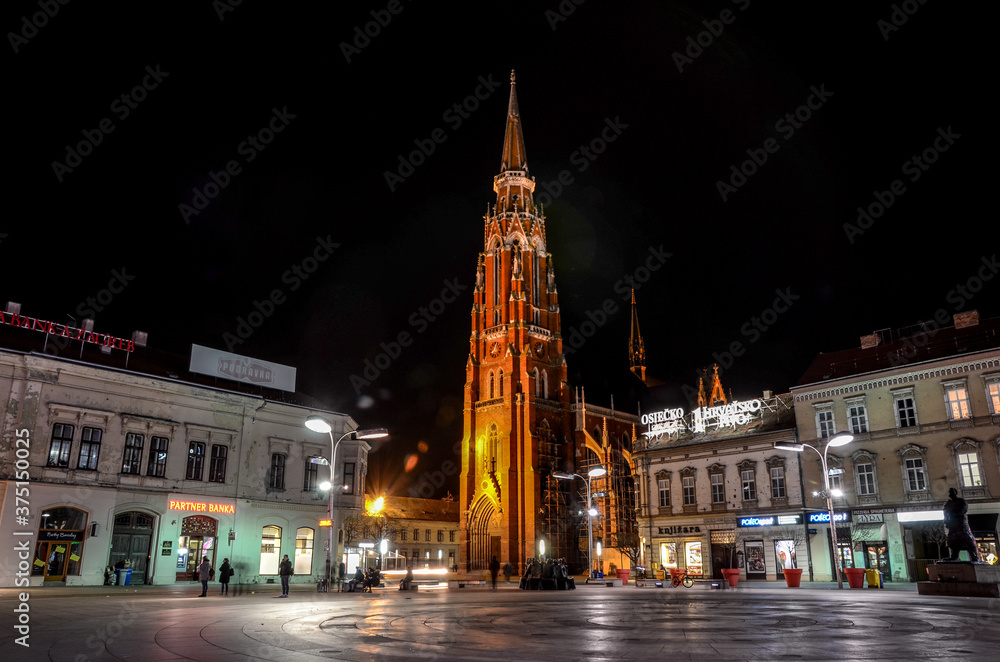 Main town square and famous cathedral by night in Osijek, Croatia ...