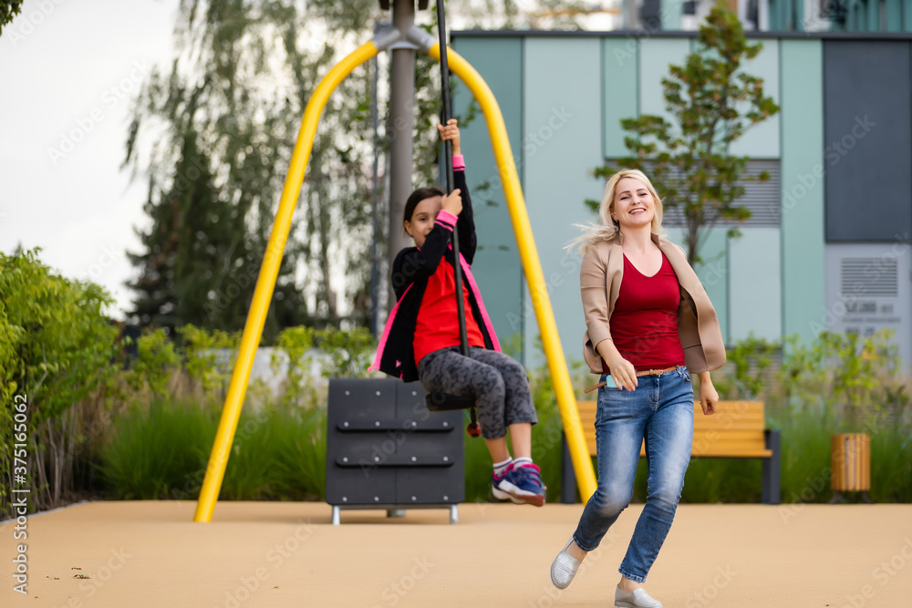 The little girl on the bungee jumping for kids outdoor. Stock Photo ...