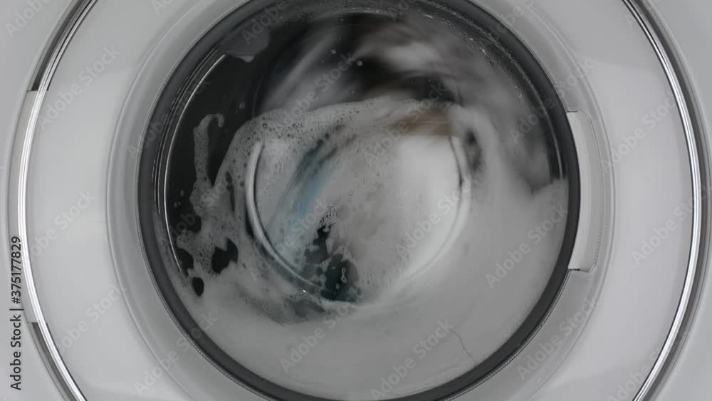 Washing machine washing clothes./ Washing clothes with laundry ...