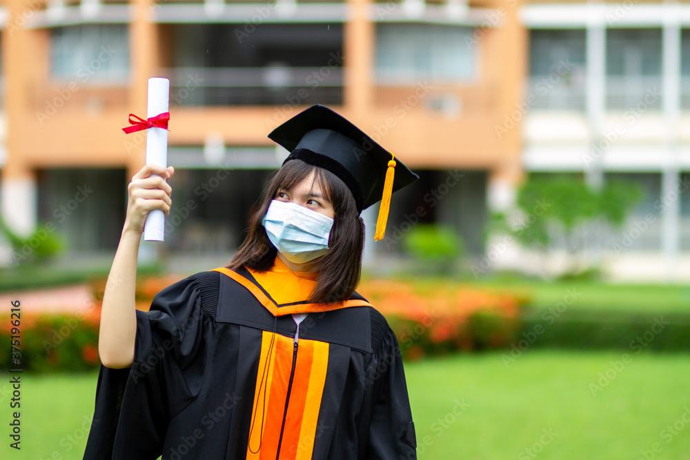 Graduation girl raises her hand to celebrate her graduation, complete ...