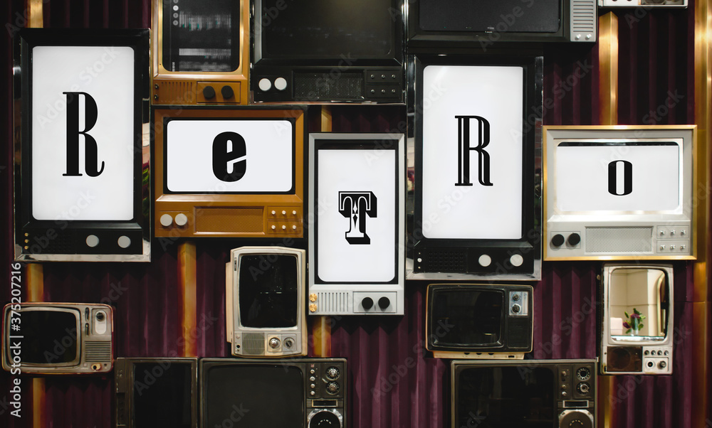 Wall mounted old-fashioned vintage tv screens displaying letters ...