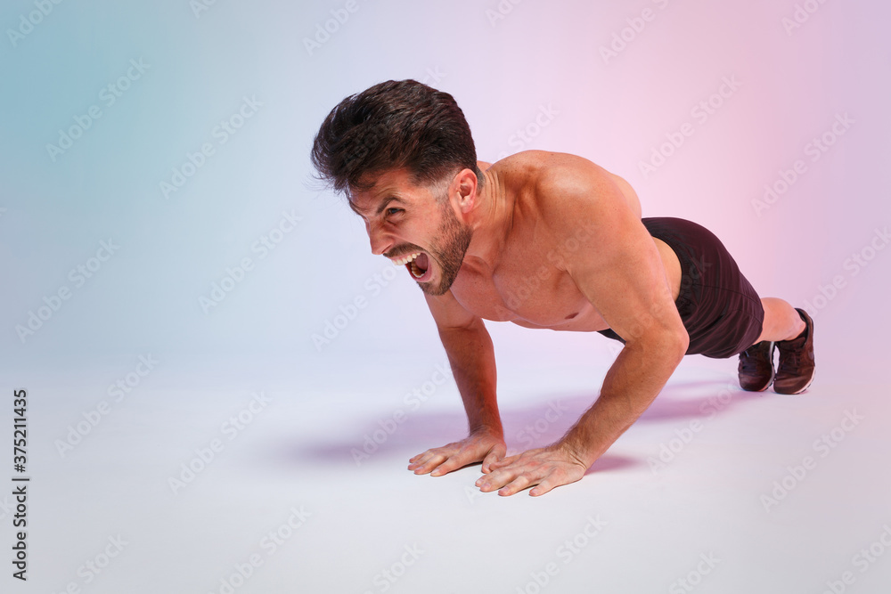 Full length portrait of screaming fitness sporty strong guy bare ...