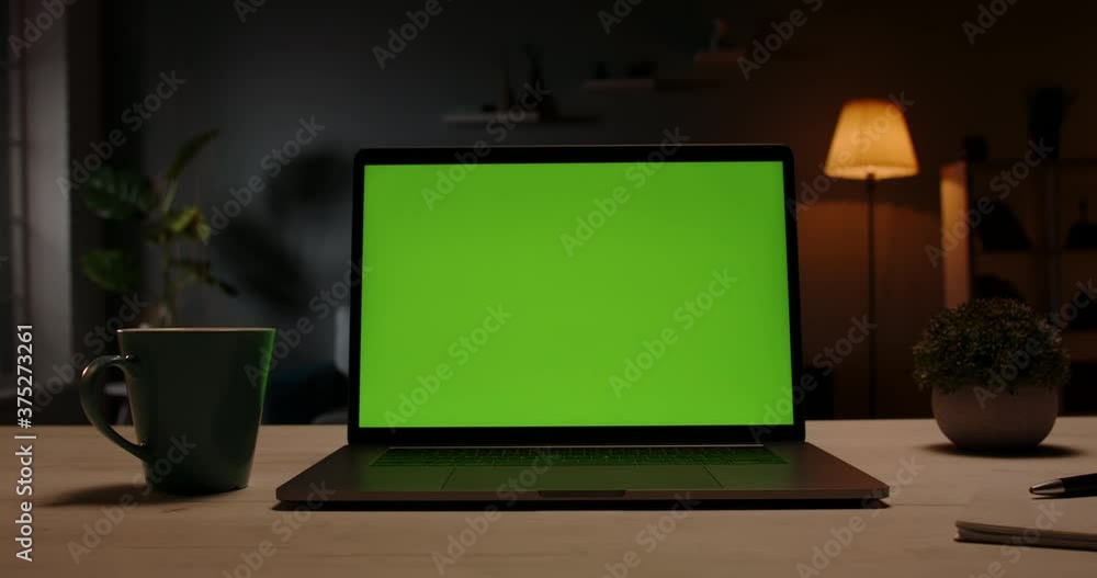 Modern laptop with template copy space green screen set on table in ...