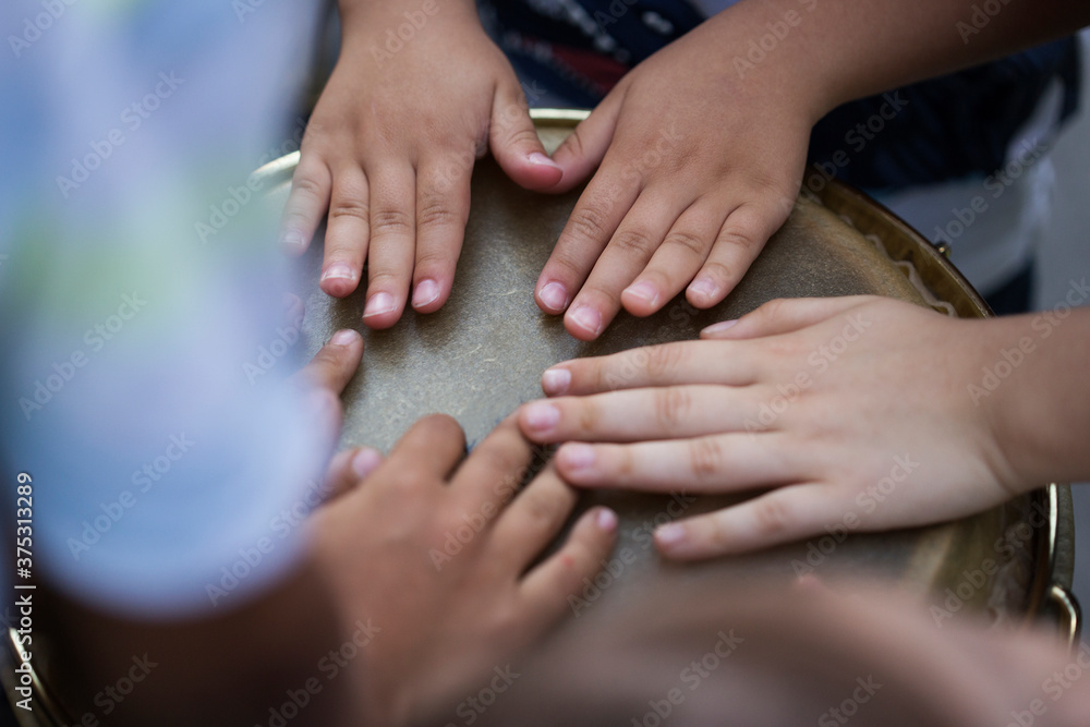 Children playing together at djembe drum, close up. Beating the djembe ...