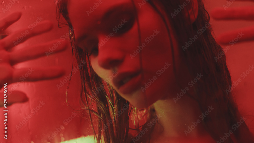 Provocative woman posing for camera in washroom in red light. Stock ...