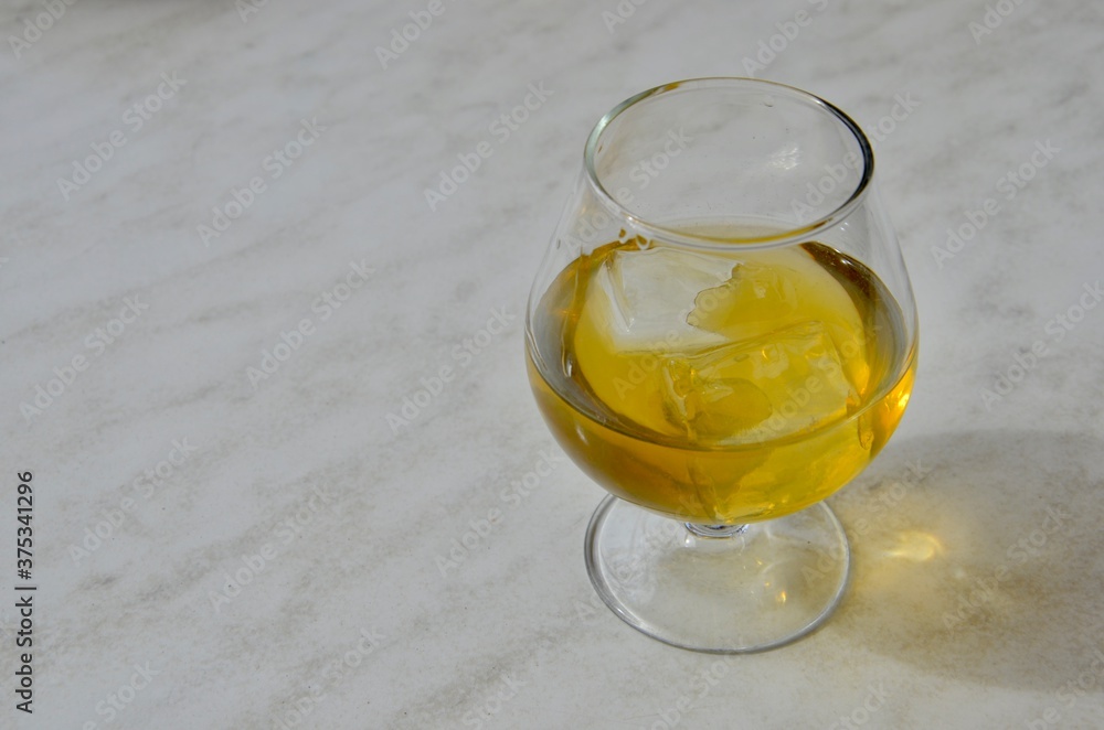 Hierbas (Herbes) liqueur or cocktail with ice in a glass, traditional ...