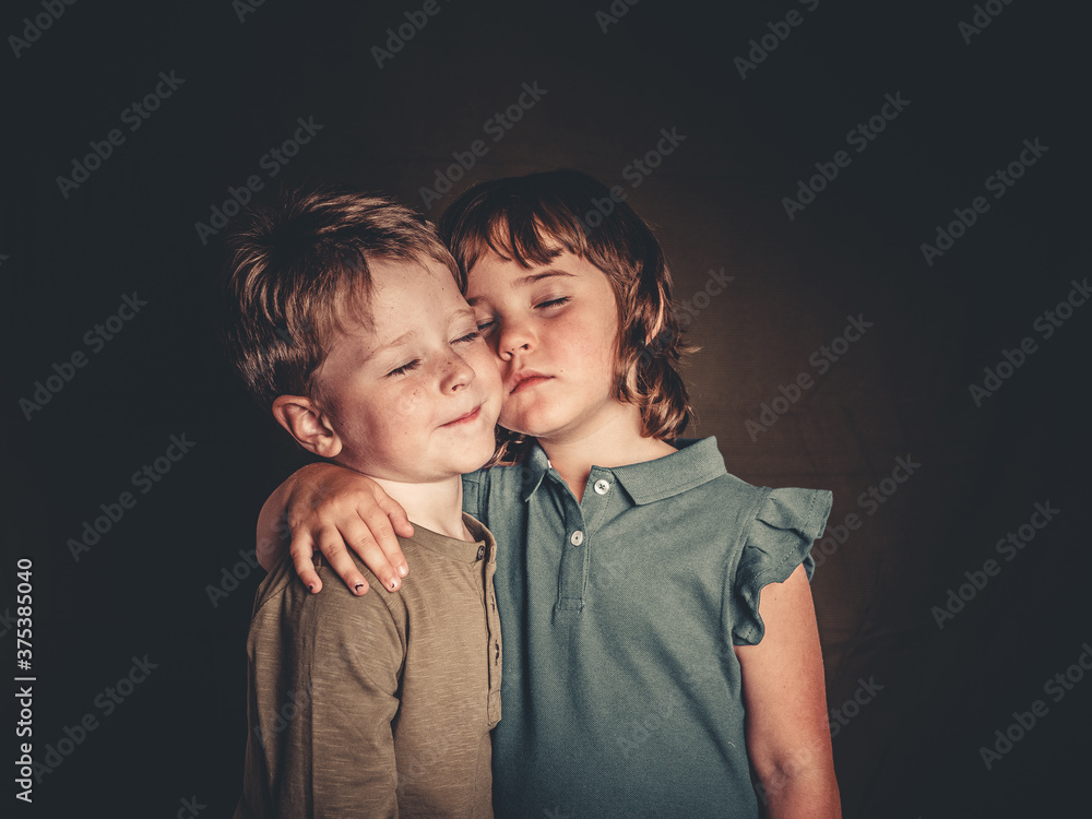 adorable picture of siblings hugging each other. Sign of union, love ...