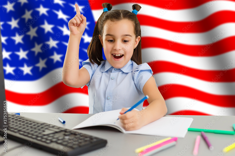 Learning language. Smart child girl on the American flag background ...