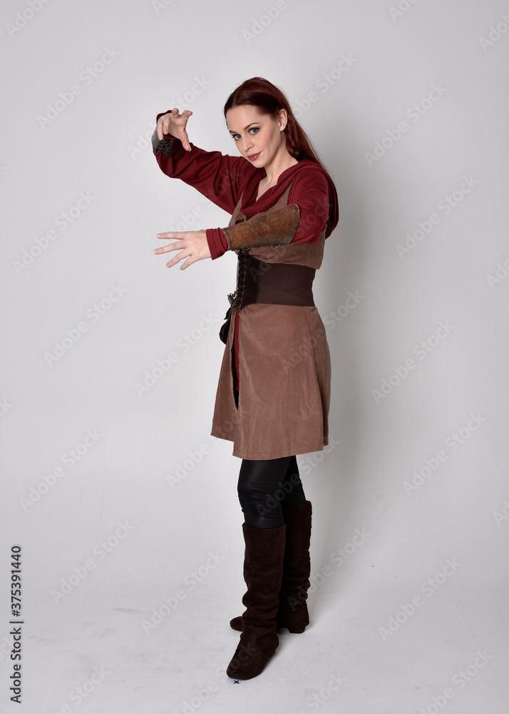 Full length portrait of girl wearing medieval costume. Standing pose ...