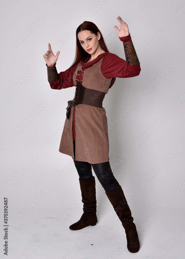 Full length portrait of girl wearing medieval costume. Standing pose ...