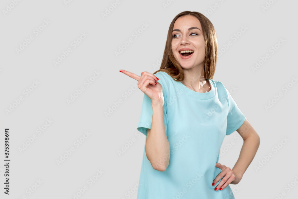 Amused woman. Special offer. Portrait of happy lady in blue pointing at ...