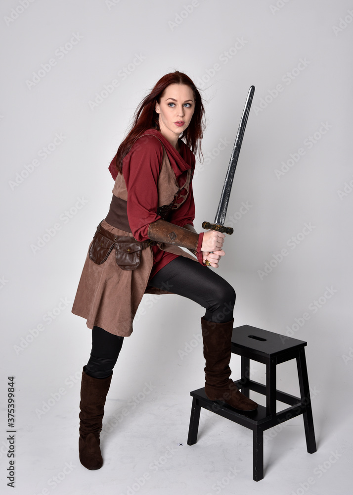 Full length portrait of girl wearing medieval costume. Standing pose ...