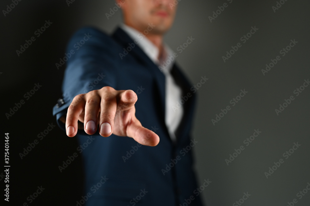 The man holds his index finger in front of him. A man in a suit points ...