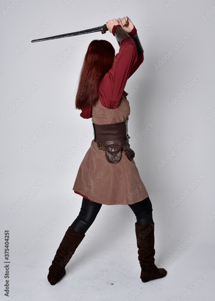 Full length portrait of girl wearing medieval costume. Standing pose ...