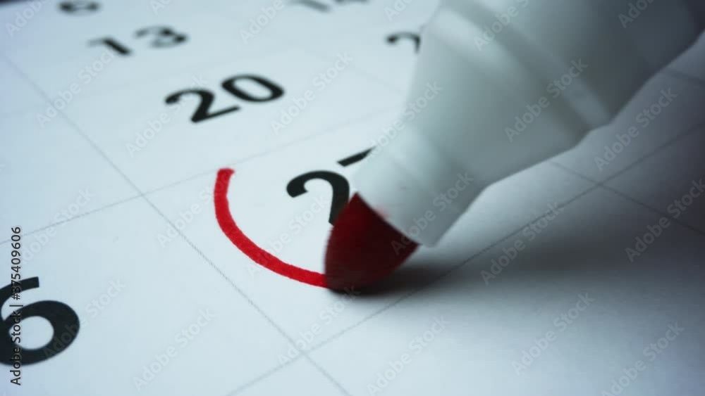 Business working day calendar. Woman marking day on calendar with ...