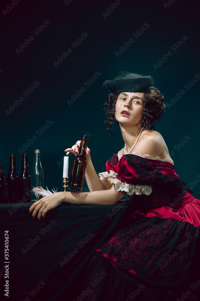 Party time. Young woman as Anna Karenina isolated on dark blue ...