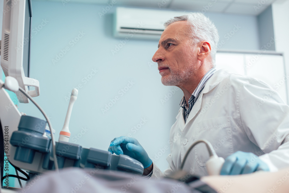 Concentration on the process while conducting ultrasound scanning Stock ...