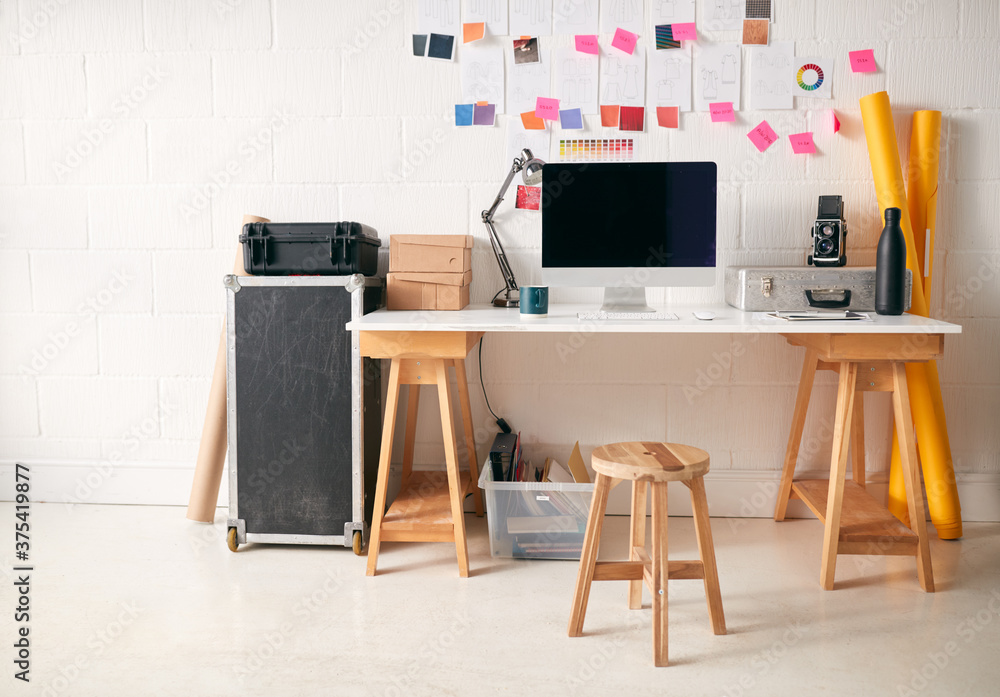 Workspace In Creative Studio With Desk And Computer In Front Of Wall ...