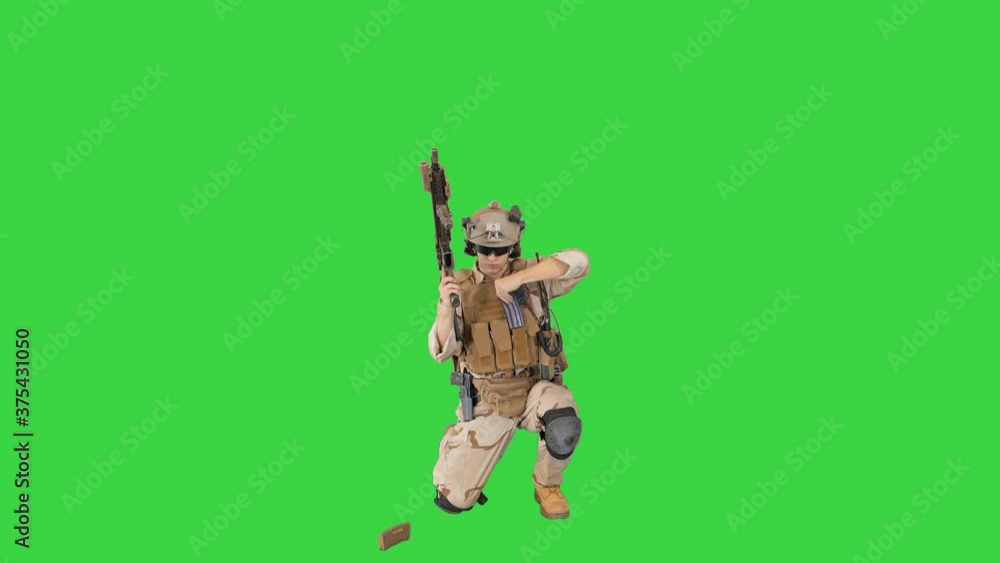 Soldier shooting with assault rifle and reloading on a Green Screen ...