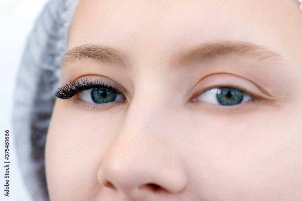 Eyelash extensions. Closeup of eyes with extended eyelashes and without ...