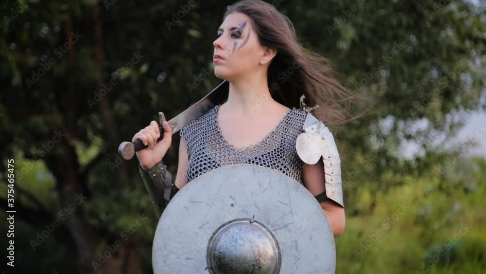 Camera movement from bottom to top, a medieval woman warrior in chain ...