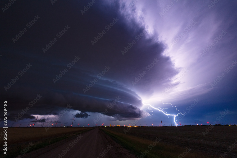 Supercell thunderstorm with lightning bolt in the night sky Stock Photo ...