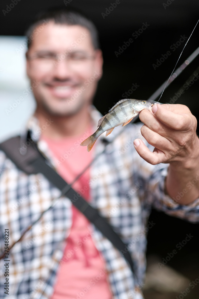 Adult Fisherman Caught a small Fish on the river and shows his haul ...