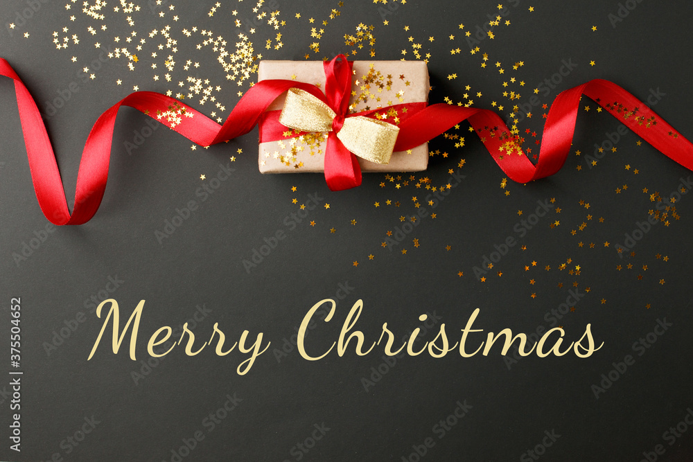 MERRY Christmas text Craft gift box on a dark background, decorated ...