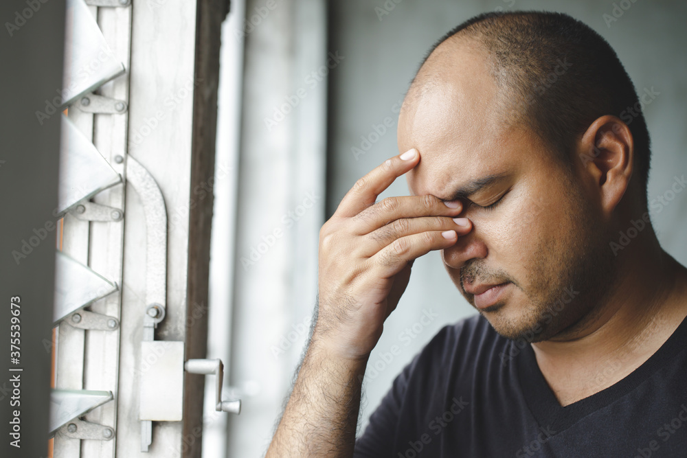 Young man close up portrait worried sad and hold the head with hand ...