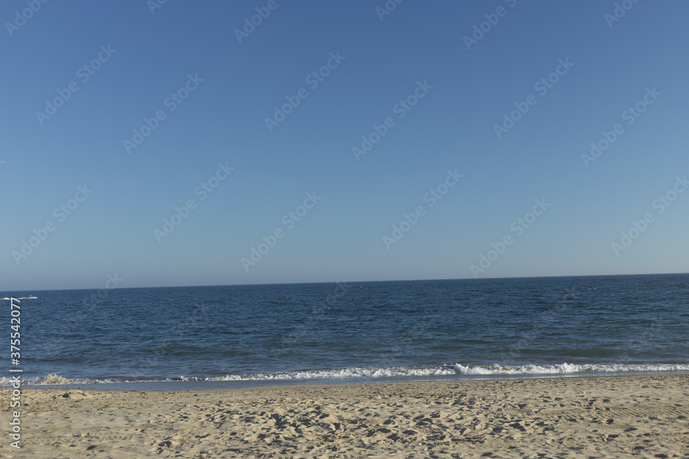 Beautiful scenery of a clean beach under a clear blue sky Stock Photo ...