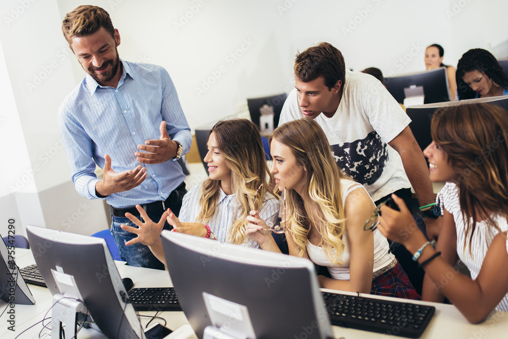 College students in a computer lab, using computers during class. Stock ...
