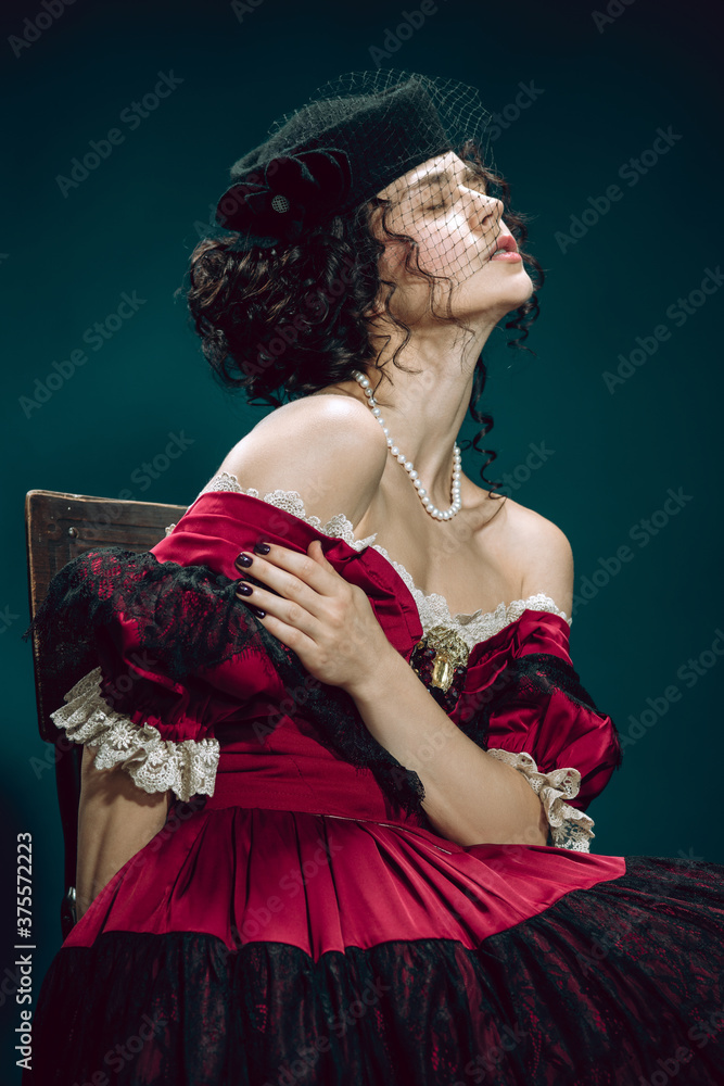 Heart hurts. Young woman as Anna Karenina isolated on dark blue ...
